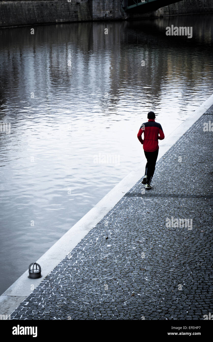 man jogging along a river Stock Photo - Alamy