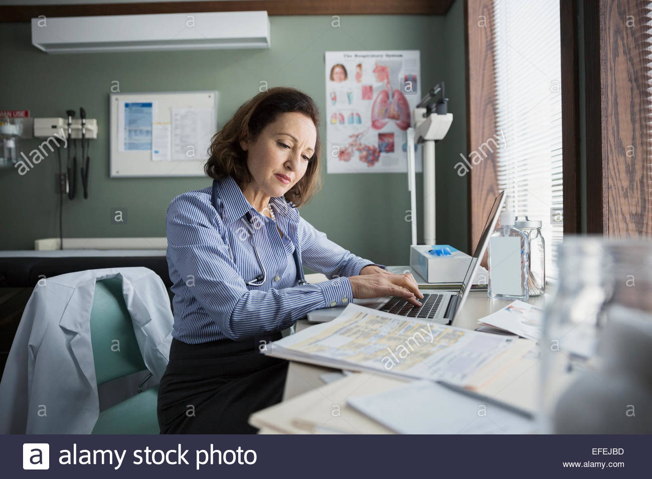 Doctor typing in office hi-res stock photography and images - Alamy
