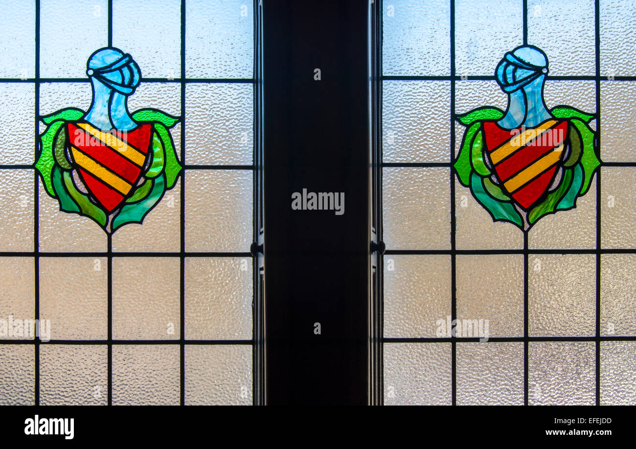 Family coat of arms in stained glass window in a northern mill building ...