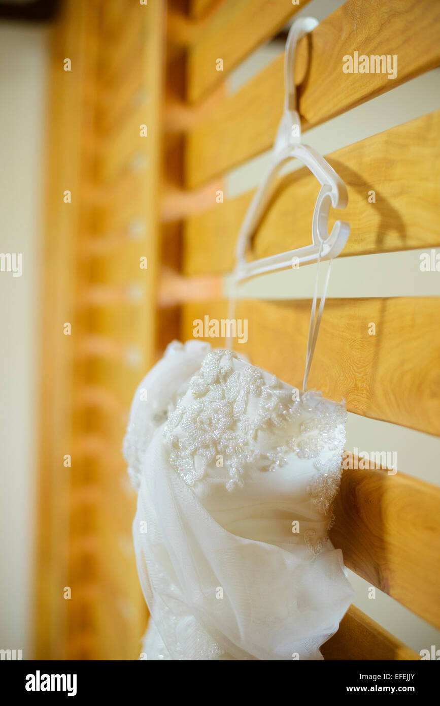 Wedding dress hanging up Stock Photo - Alamy