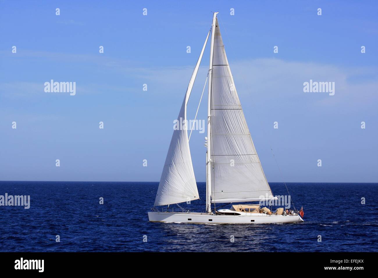 Sloop sailing in open waters Stock Photo - Alamy