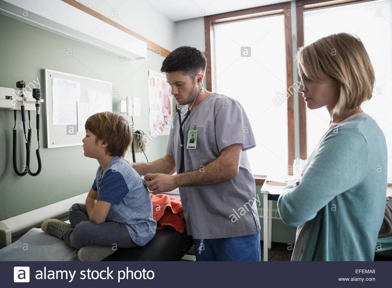 Male nurse using stethoscope on boy Stock Photo - Alamy