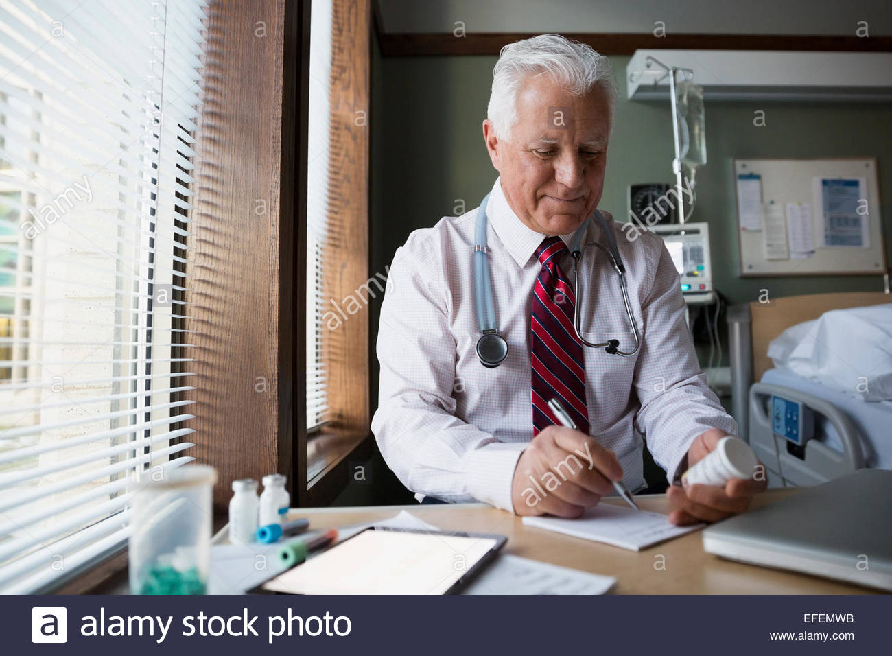 Doctor writing prescription in hospital Stock Photo - Alamy