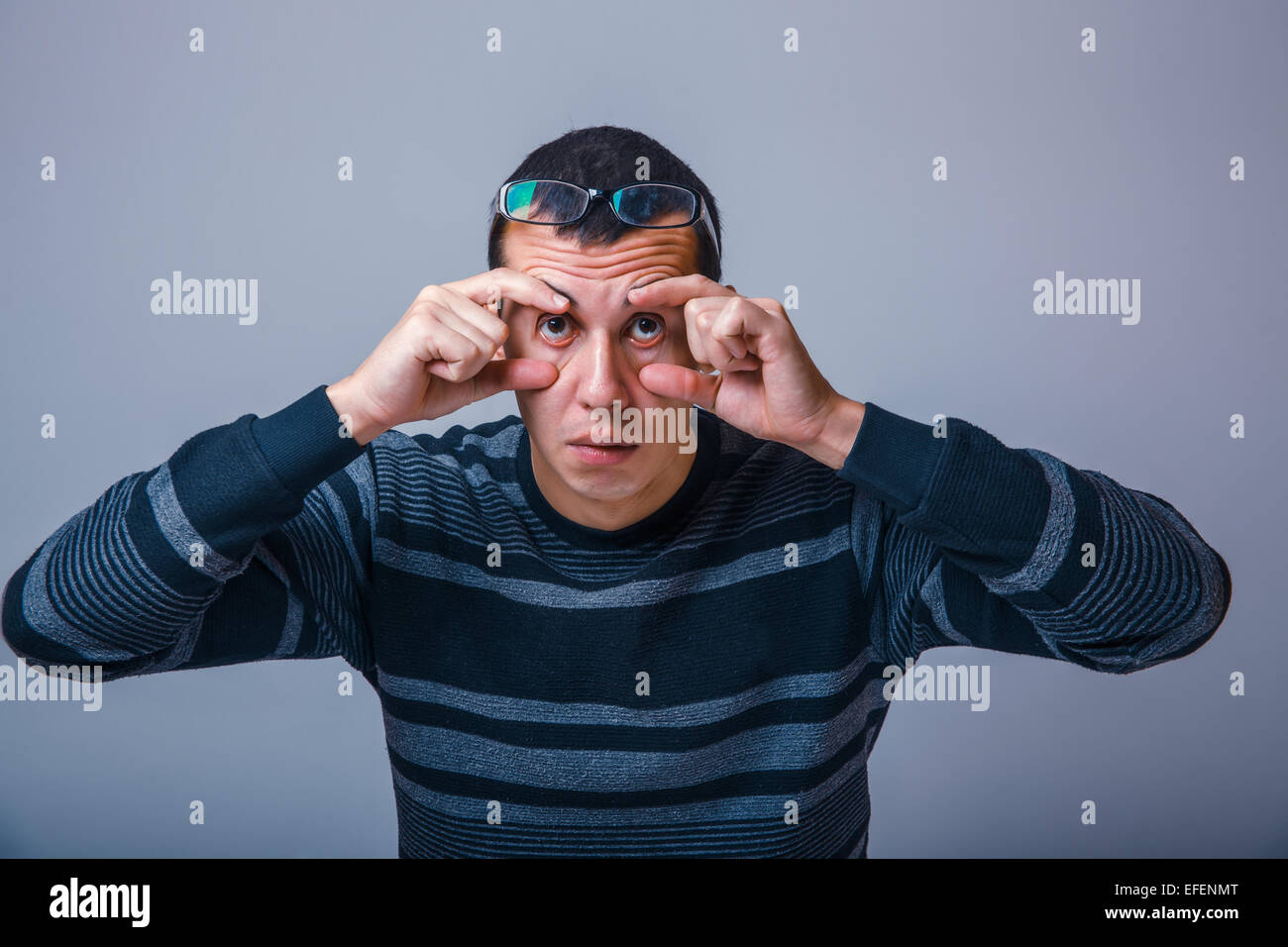 European-looking male of about thirty brunet stretches eyes with Stock ...