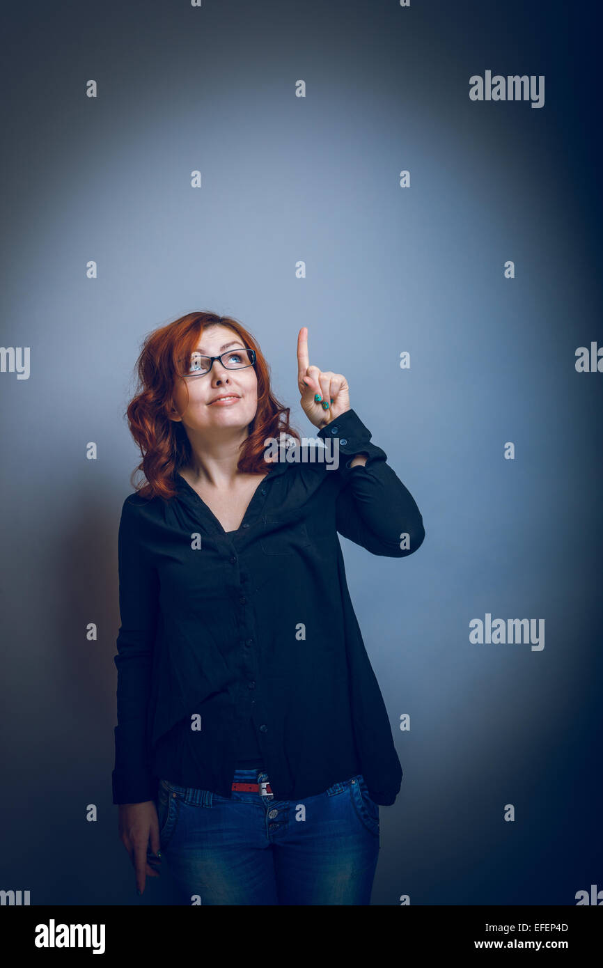 European-looking woman of about thirty redhead shows his hand up Stock ...