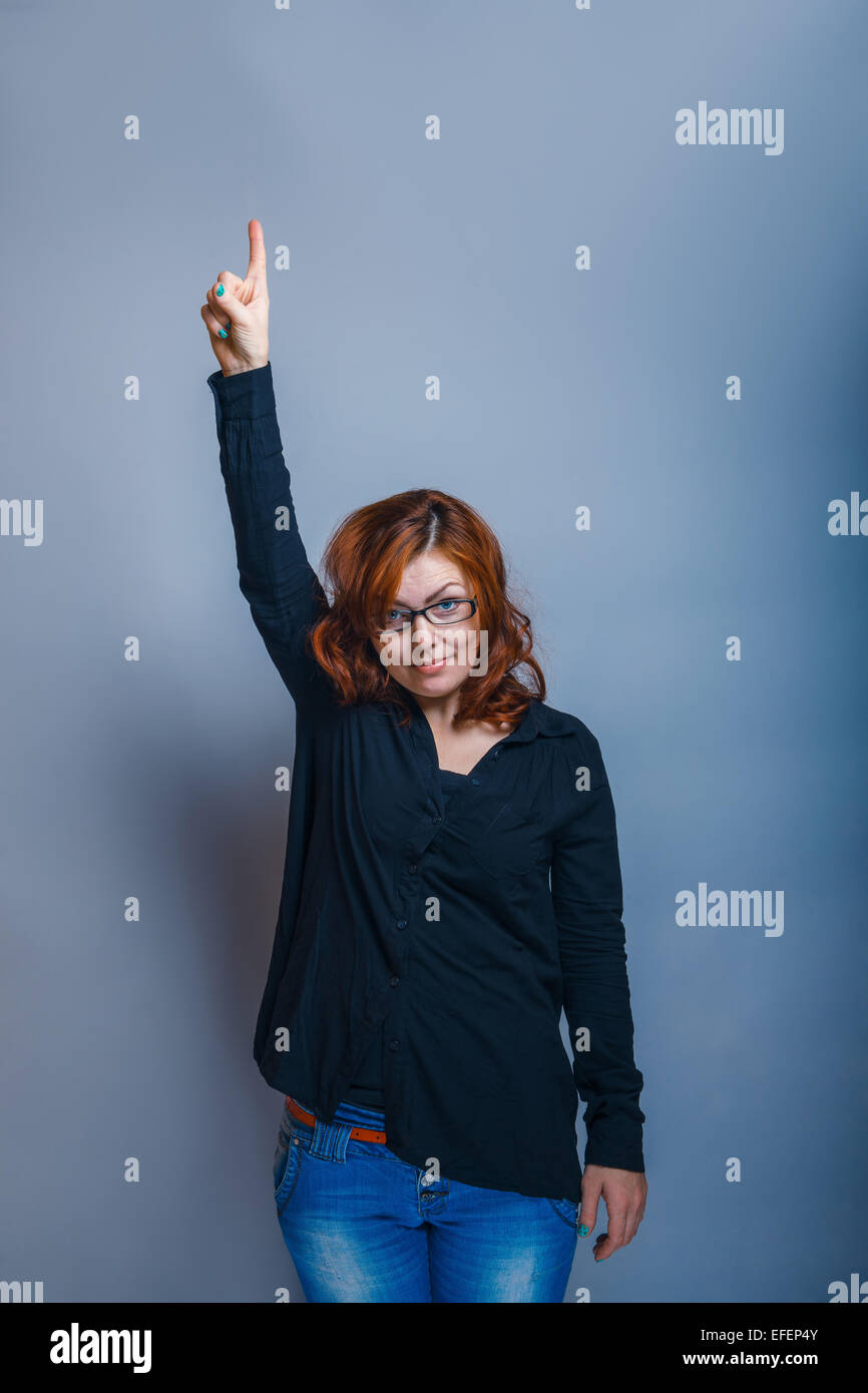 European -looking woman of 30 years is pointing in the direct Stock ...