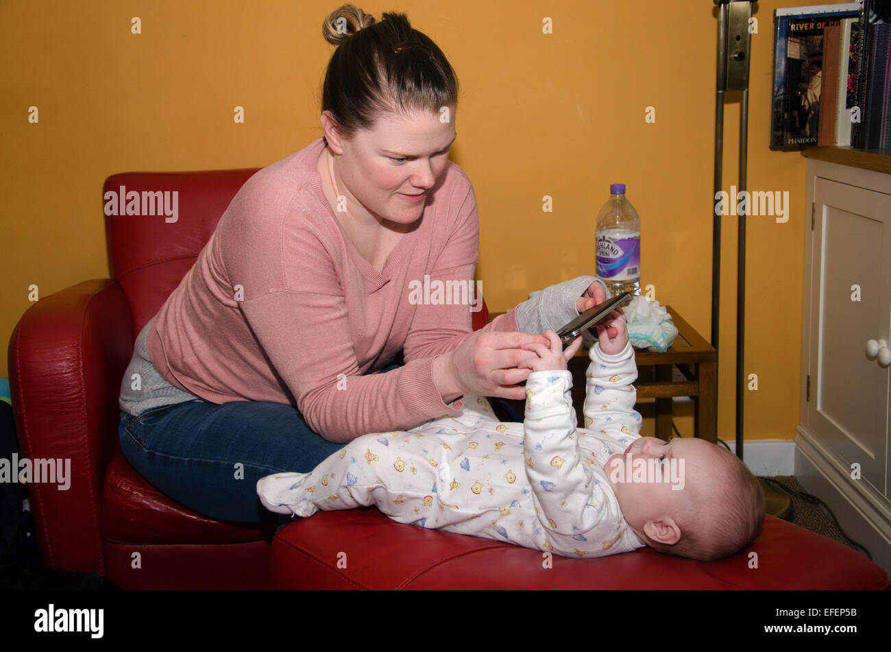 A mother playing with her five month old baby bonding through play ...