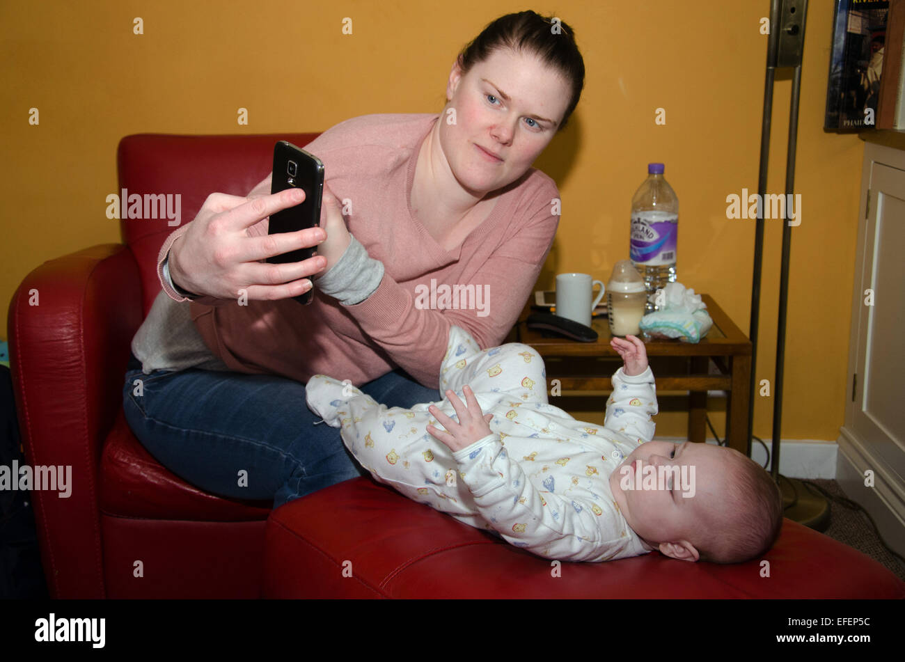 A mother with her five month old baby bonding through play Stock Photo ...