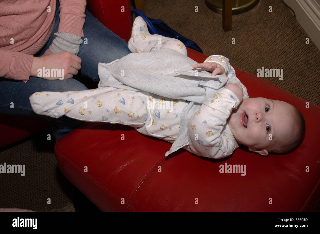 A happy five month old baby lying on her back smiling Stock Photo - Alamy