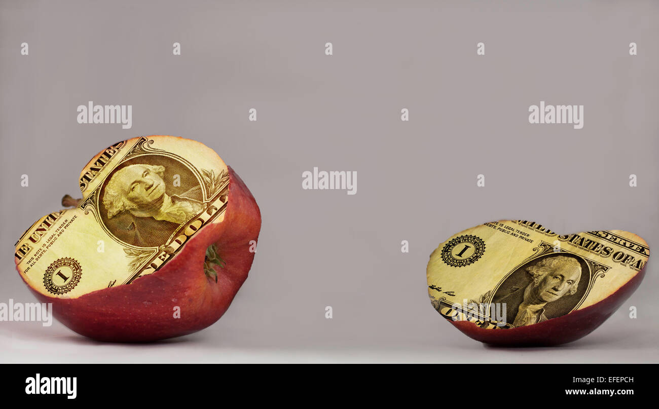 Apple slices with dollars in the middle Stock Photo - Alamy