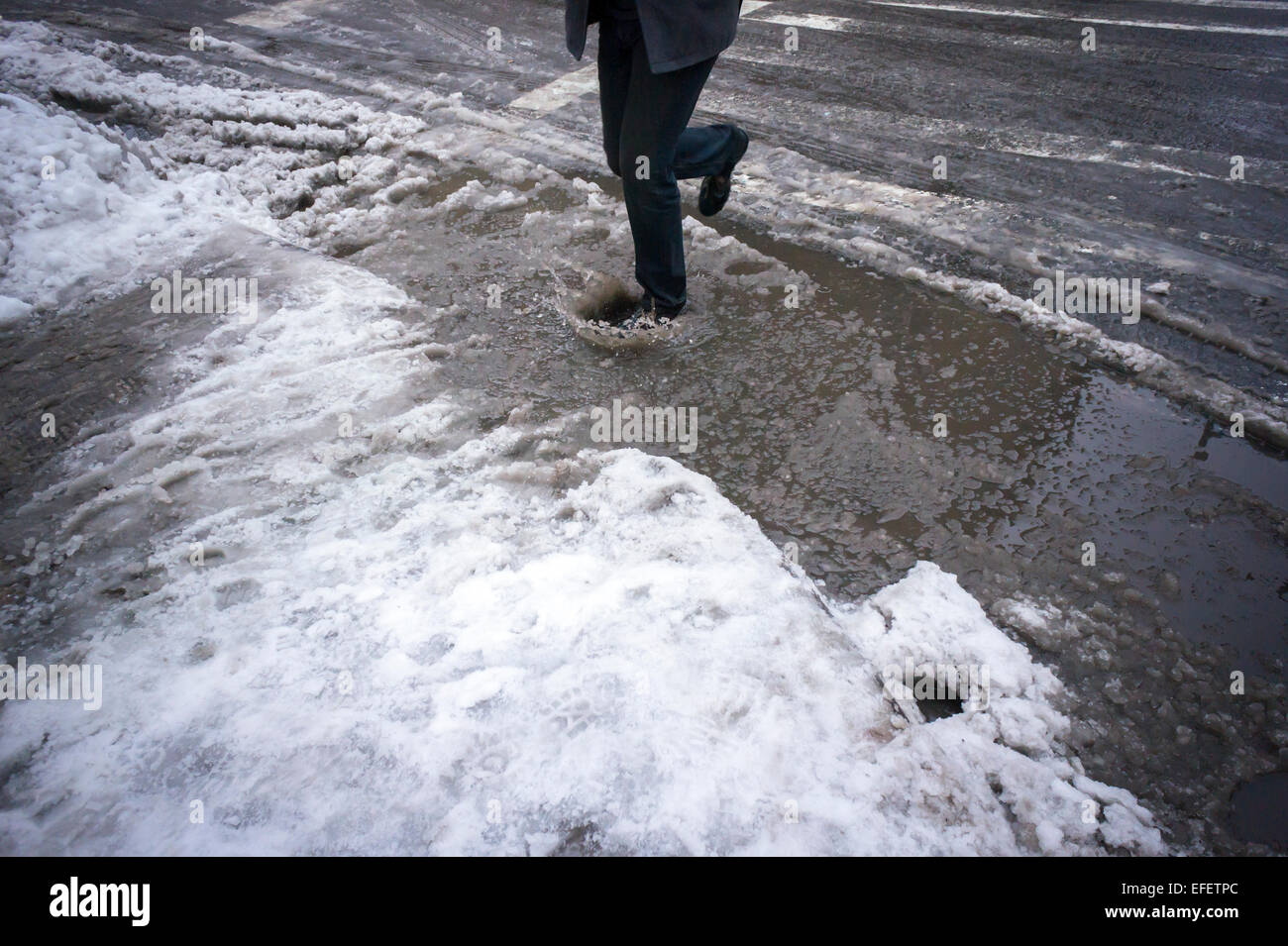 People Crossing The Street In Snow