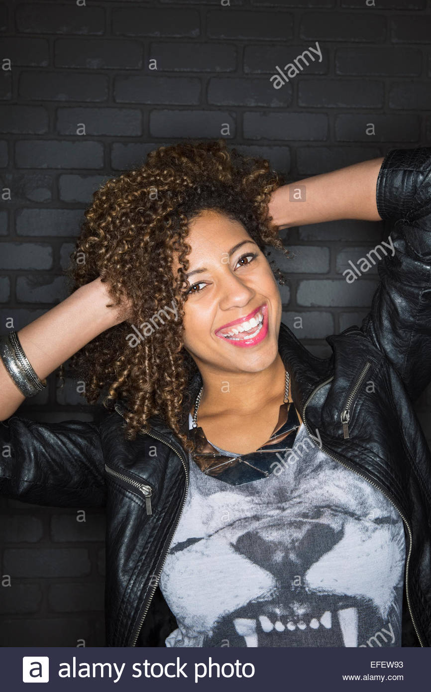 Portrait of confident woman with hands in hair Stock Photo - Alamy