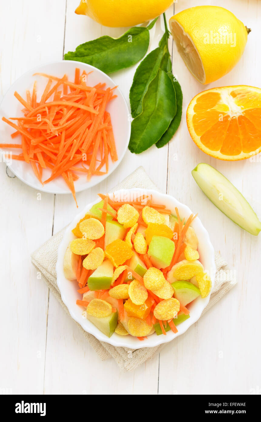 Fruit salad with cornflakes on white wooden table, top view Stock Photo ...