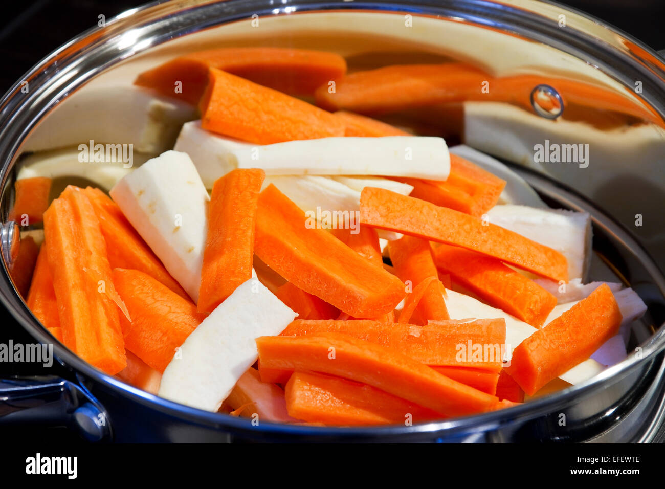 Landscape photograph of cut parsnips and carrots in a metal pan Stock ...