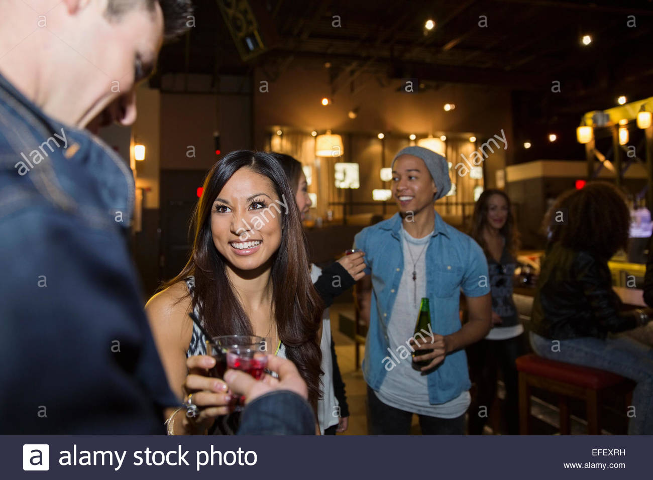 Man woman talking at bar standing holding drink hi-res stock ...