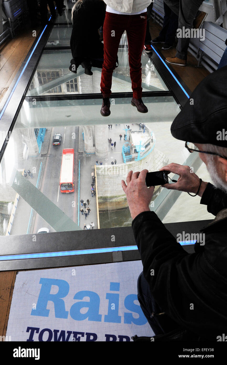 Visitors on the new glass floor in Tower Bridge. One of the bridge’s ...