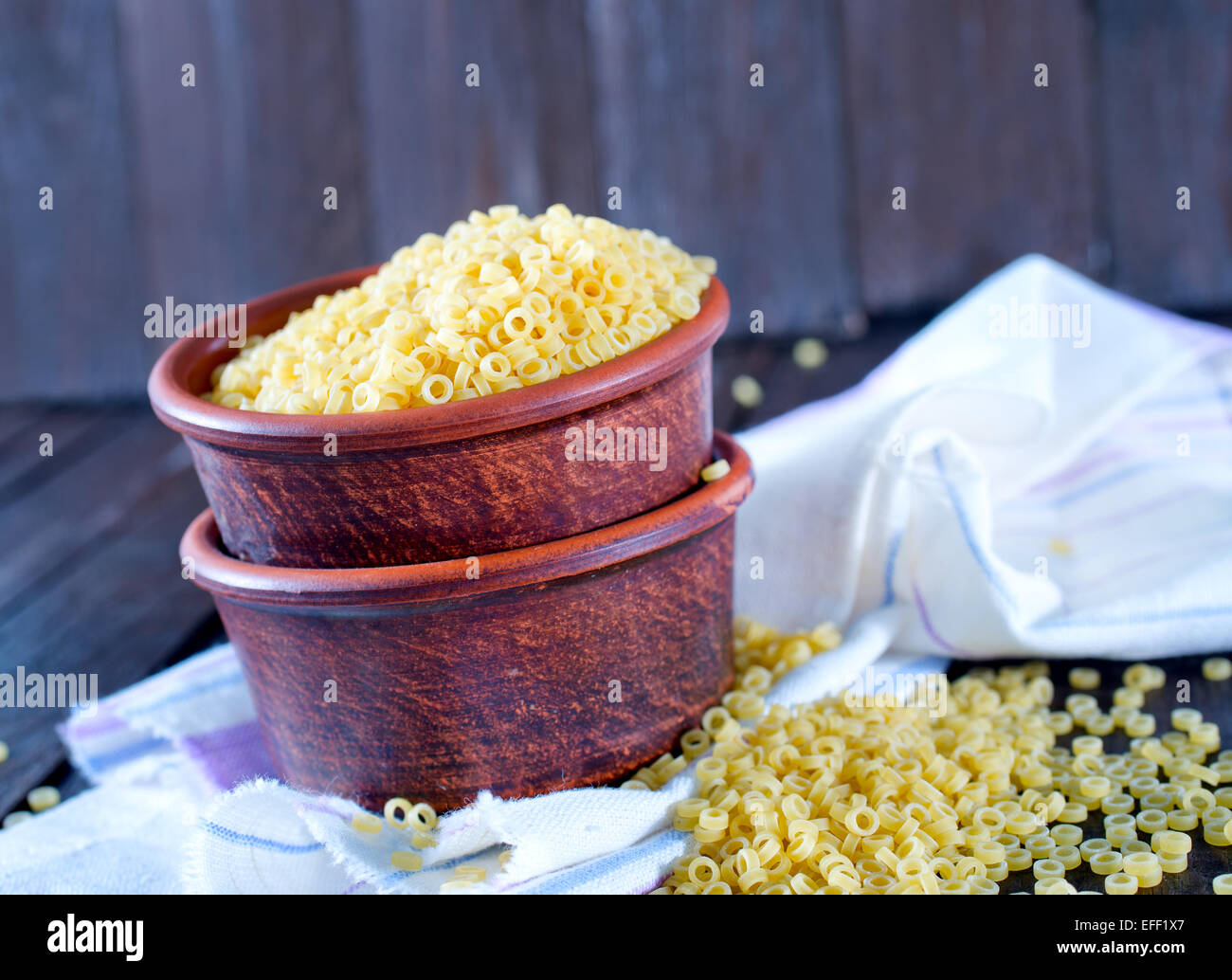 raw pasta in bowl and on a table Stock Photo - Alamy