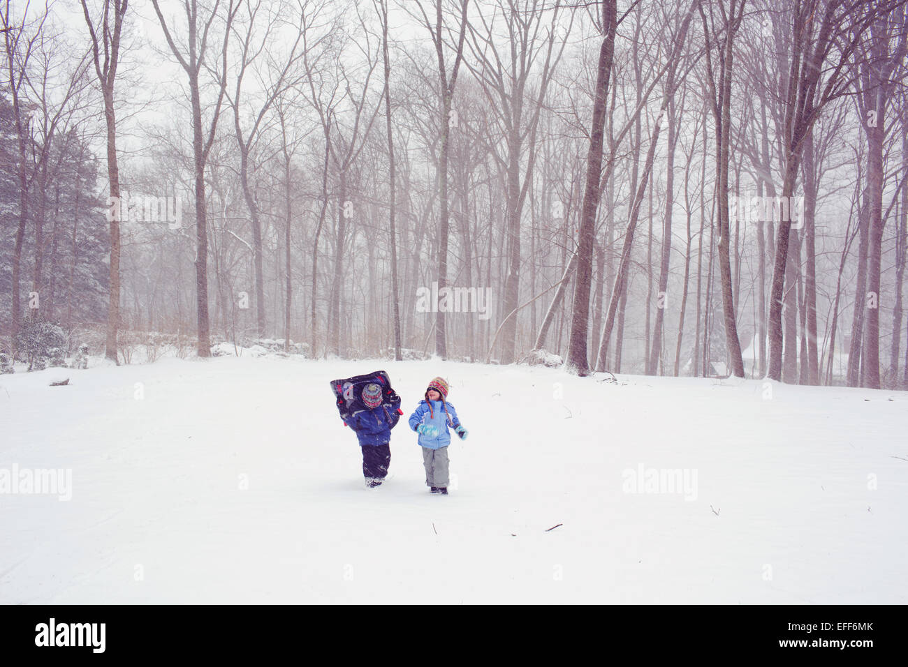 A young boy and girl playing outsidel during the 2013 Blizzard Nemo in ...