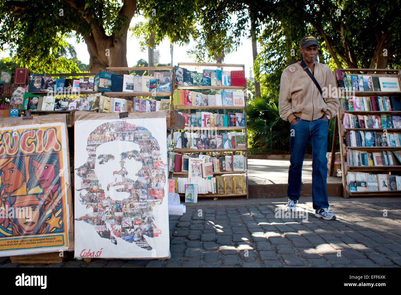 Havana, Cuba. 28th Jan, 2015. A man smokes a cigar as he stands between ...