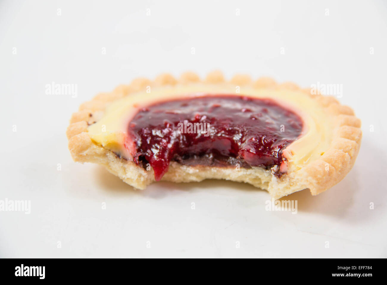 A single raspberry jam filled tart isolated on a white background Stock ...