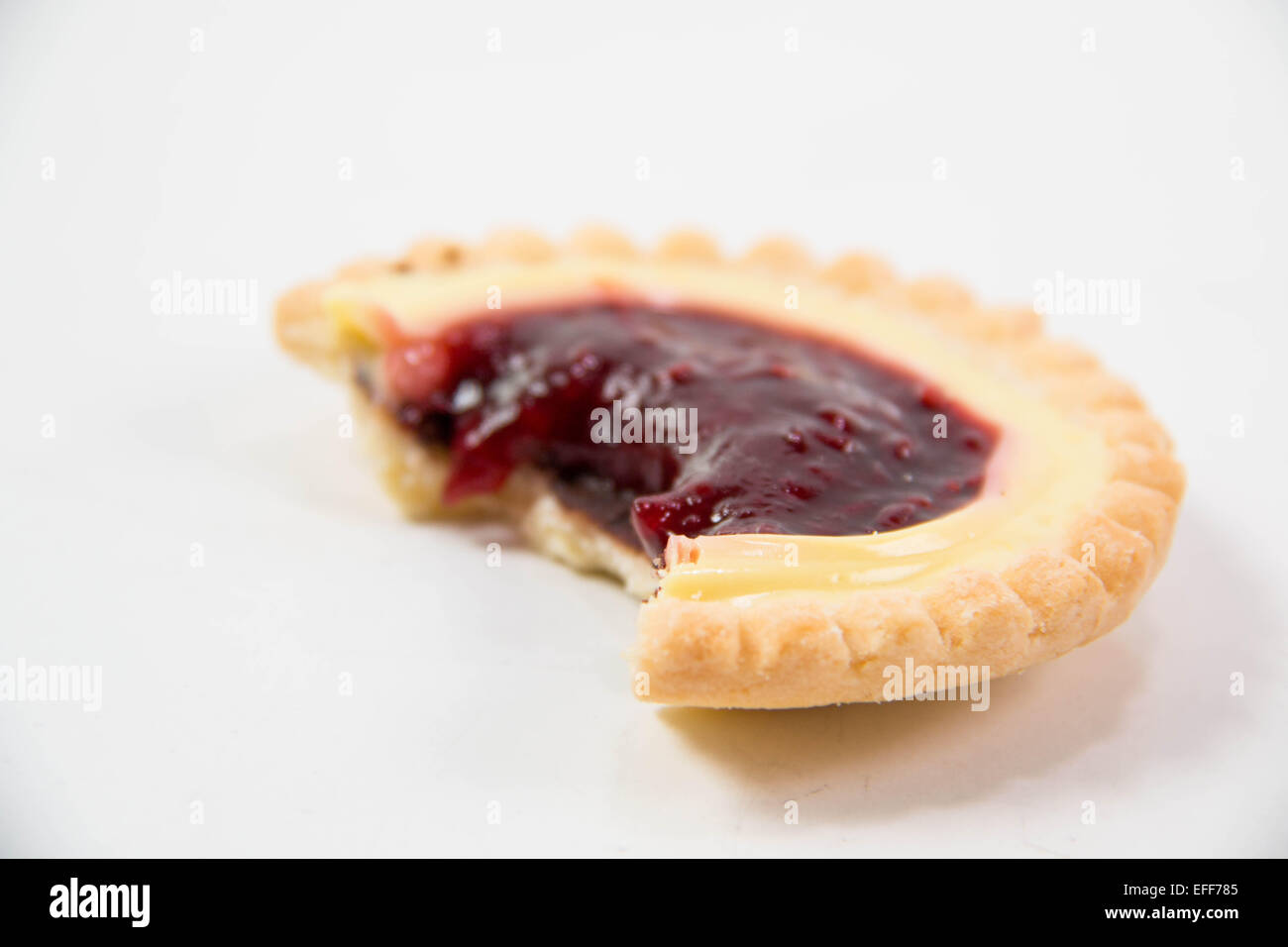 A single raspberry jam filled tart isolated on a white background Stock ...