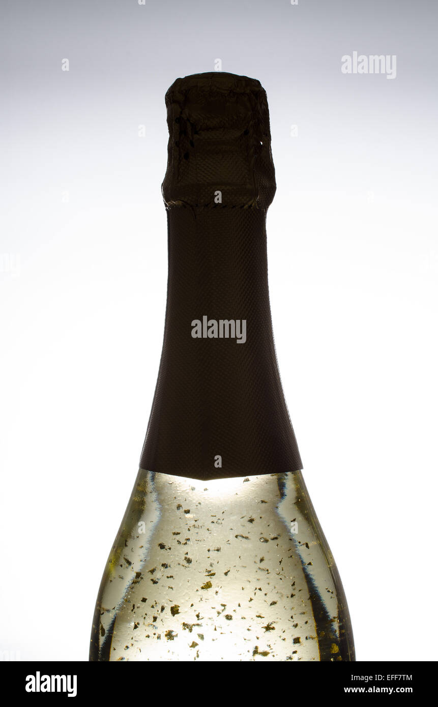Sparkling wine with gold inside, backlight exposure Stock Photo - Alamy