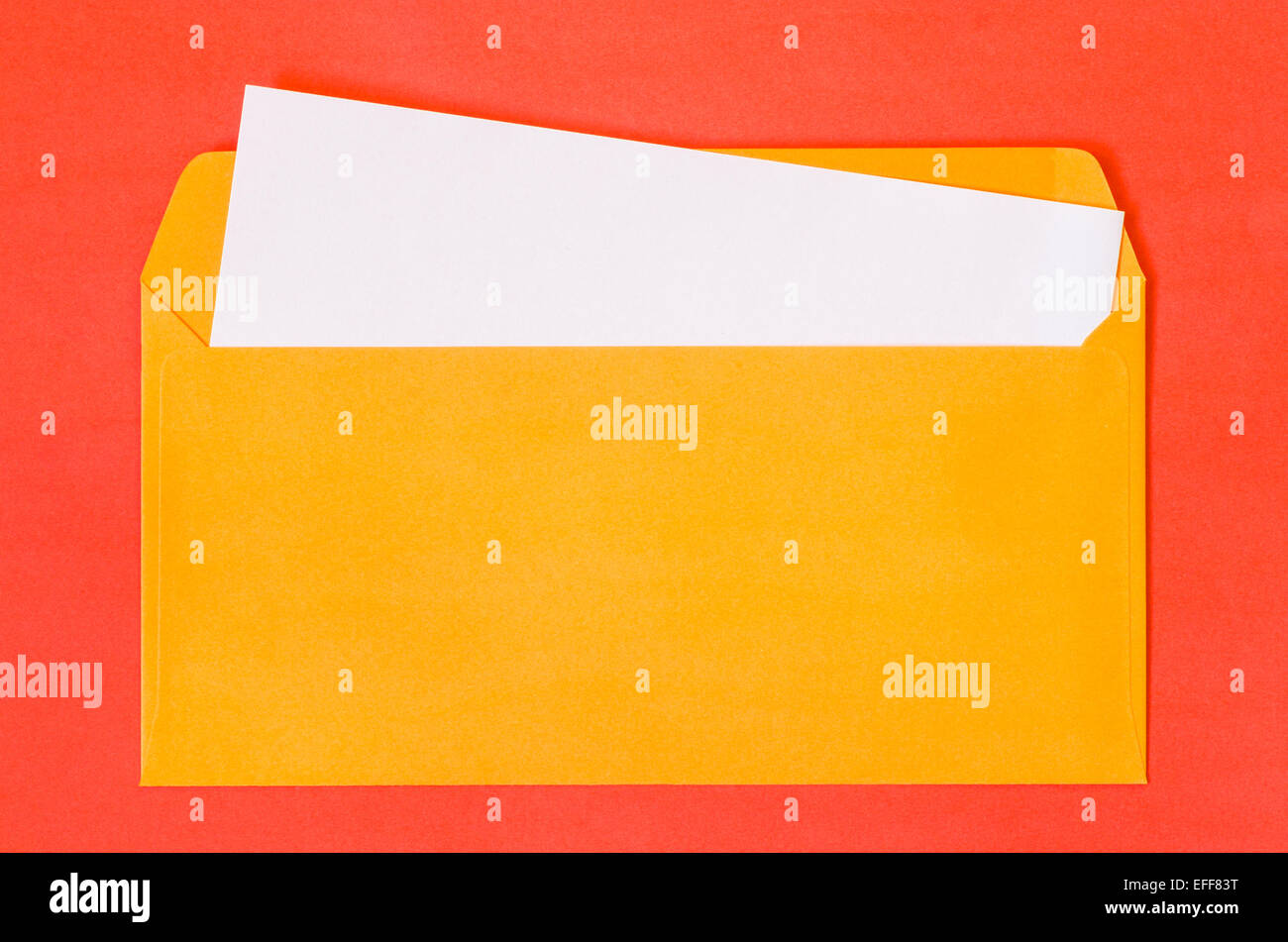 open orange envelope with blank paper on red background Stock Photo - Alamy