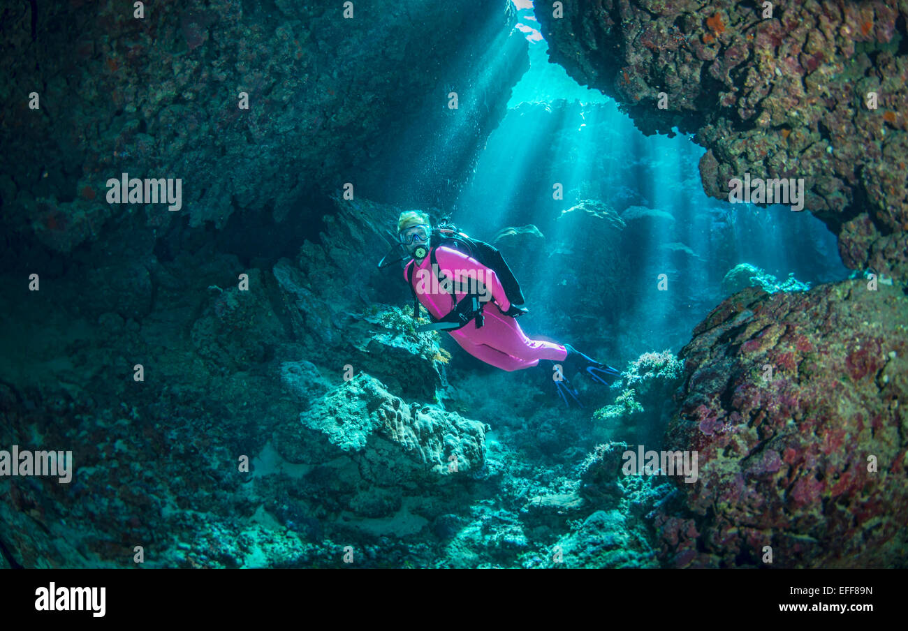 Female scuba diver exploring underwater caves Stock Photo - Alamy