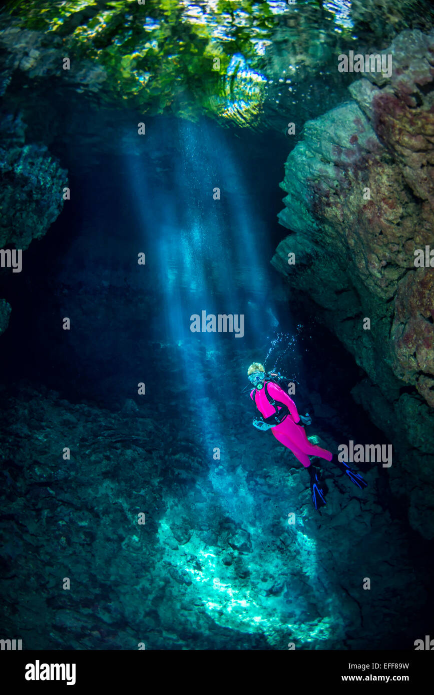 Female scuba diver exploring underwater caves Stock Photo - Alamy