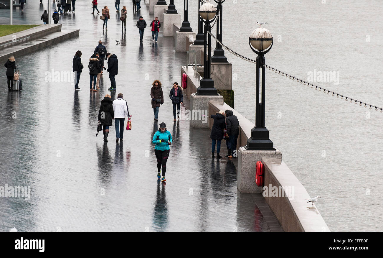 People walking along the Queens Walk on the South Bank in London Stock ...