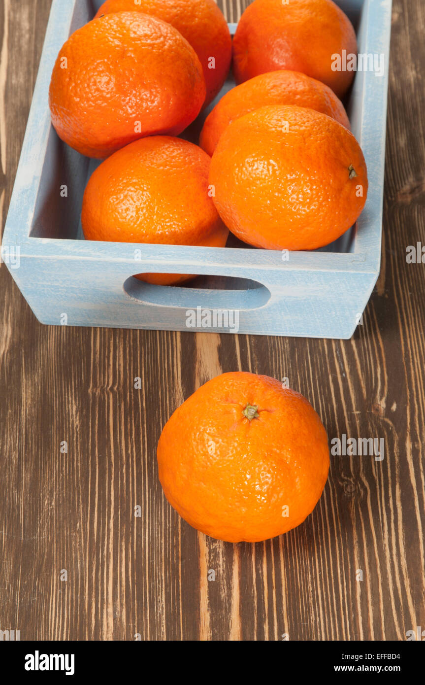 Tangerine fruits in a timber box on a wooden table Stock Photo - Alamy
