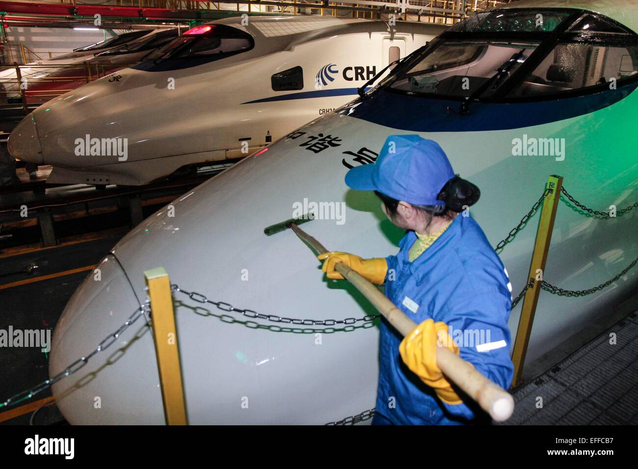 A cleaner is washing bullet train to welcome the coming 2015 spring ...