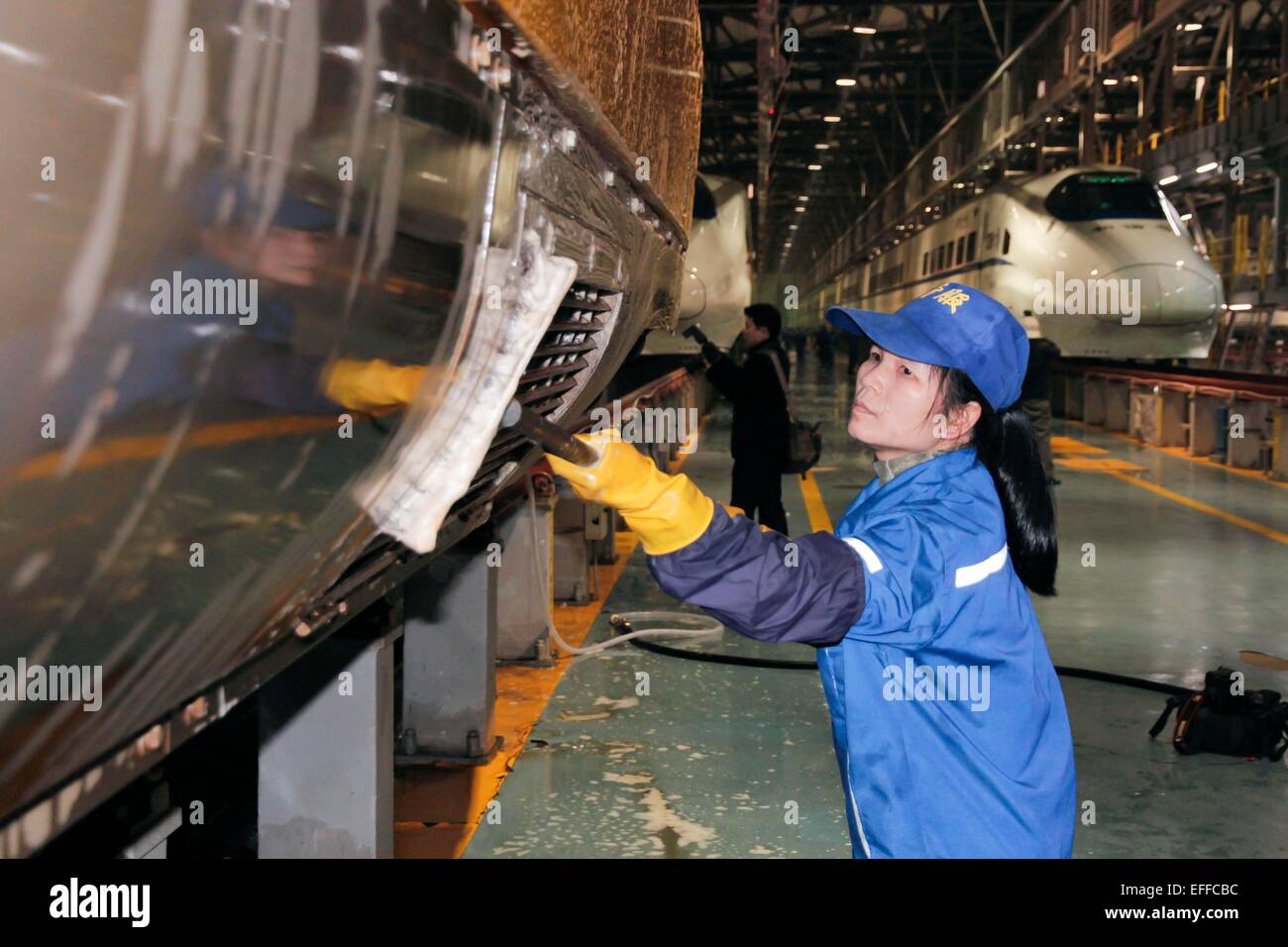 A cleaner is washing bullet train to welcome the coming 2015 spring ...