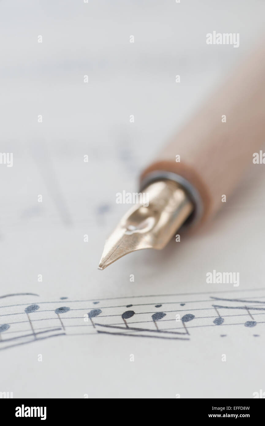 Quill on classical sheet music Stock Photo - Alamy