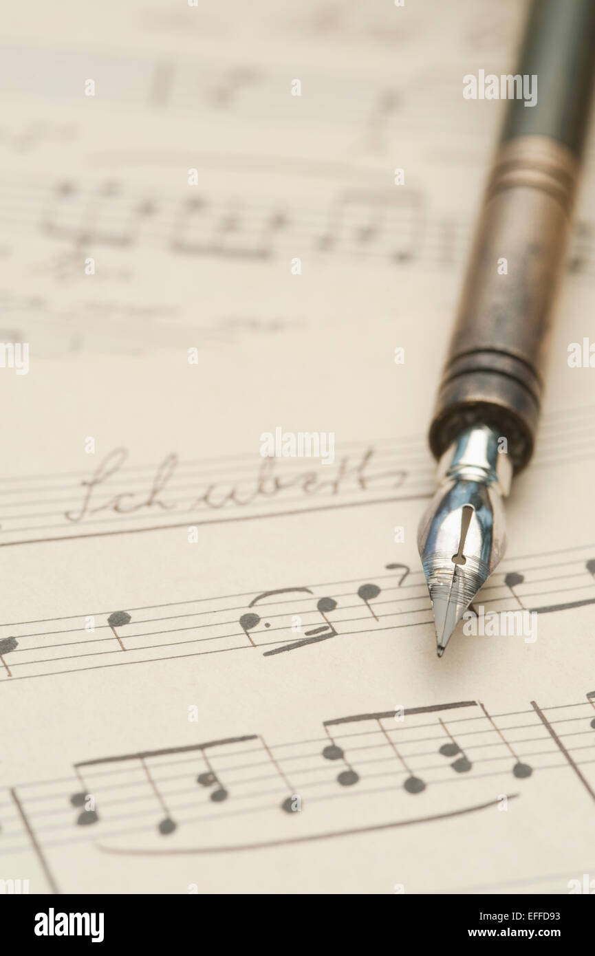 Quill on classical sheet music Stock Photo - Alamy