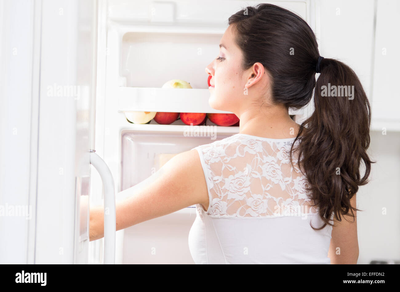 young beautiful woman searching for food in the fridge Stock Photo - Alamy