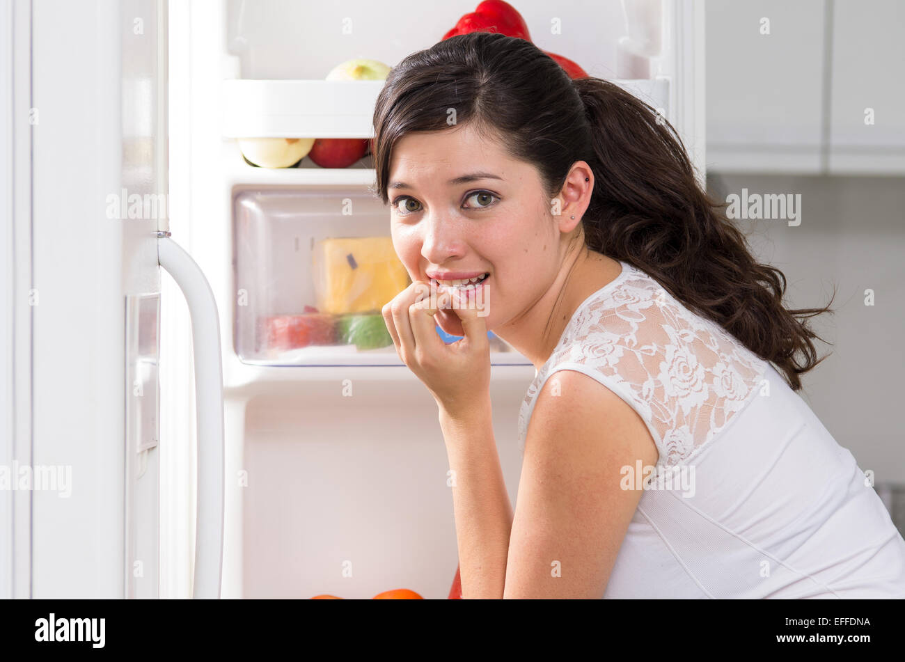 young beautiful woman searching for food in the fridge Stock Photo - Alamy