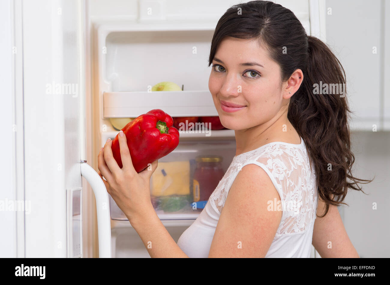 young beautiful woman searching for food in the fridge Stock Photo - Alamy