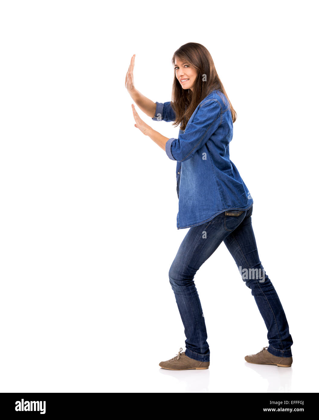 Beautiful woman push something over a white background Stock Photo - Alamy