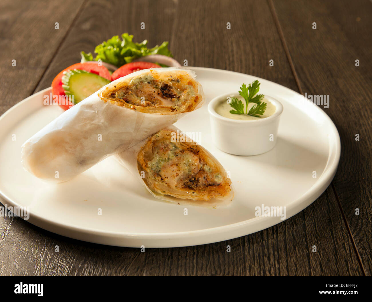 Traditional roll kebab paratha tikka wrap served on a plate with ...