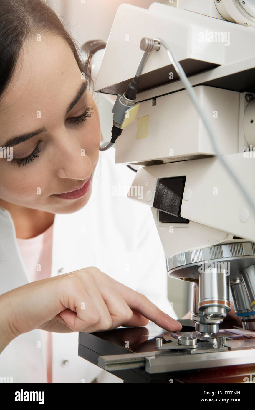 Female scientist working on microscope Stock Photo - Alamy