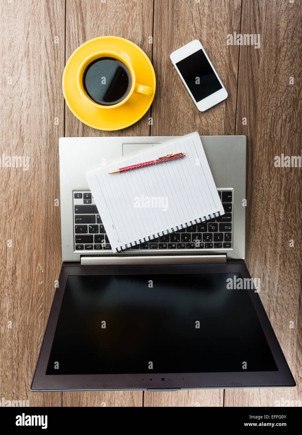 Office desk with laptop computer, notebook, mobile smartphone and ...