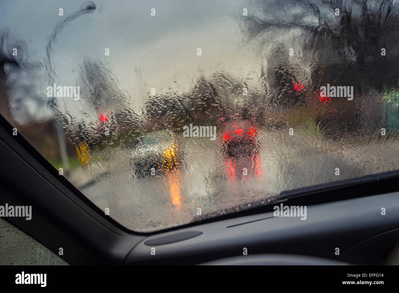 Germany, Grevenbroich, View through windscreen at crossroad at rainy ...