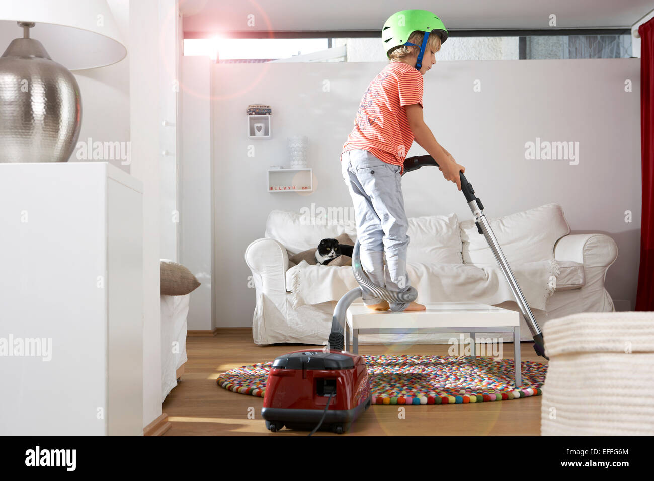 Boy in living room hoovering Stock Photo - Alamy