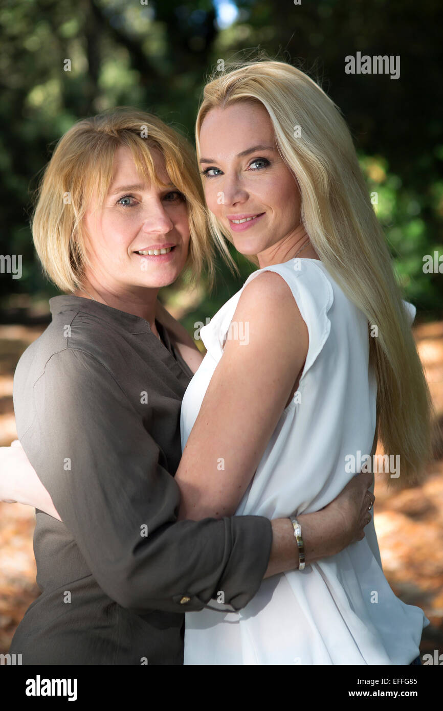 Mother and adult daughter embracing in park Stock Photo - Alamy
