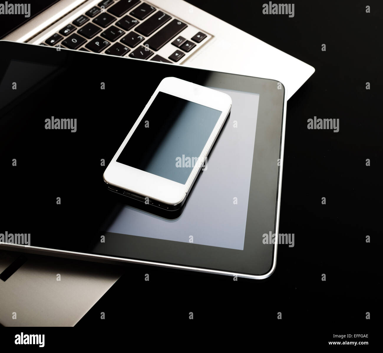 keyboard with phone and tablet pc on black background Stock Photo - Alamy