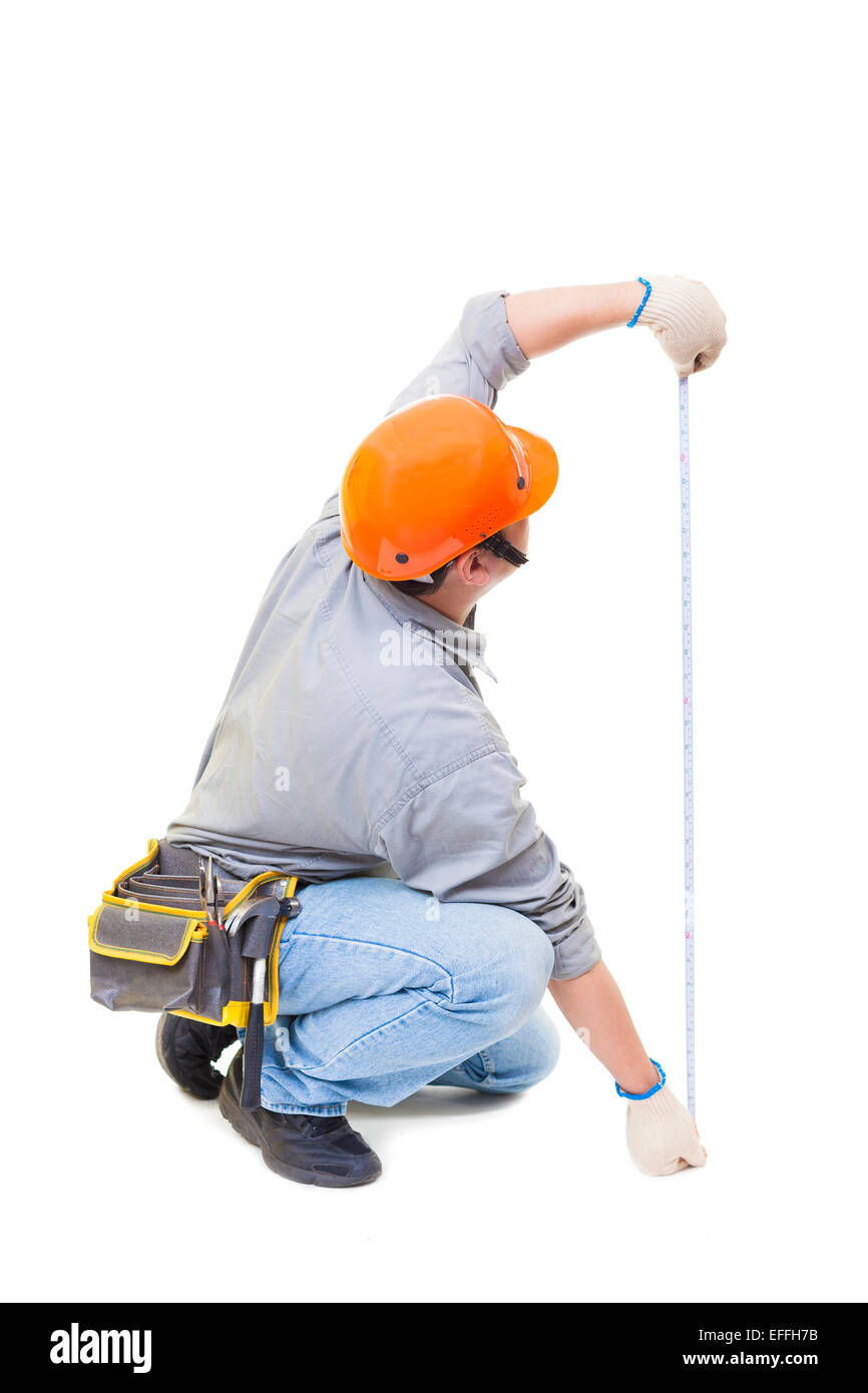 Worker with a tape measure isolated on white Stock Photo - Alamy