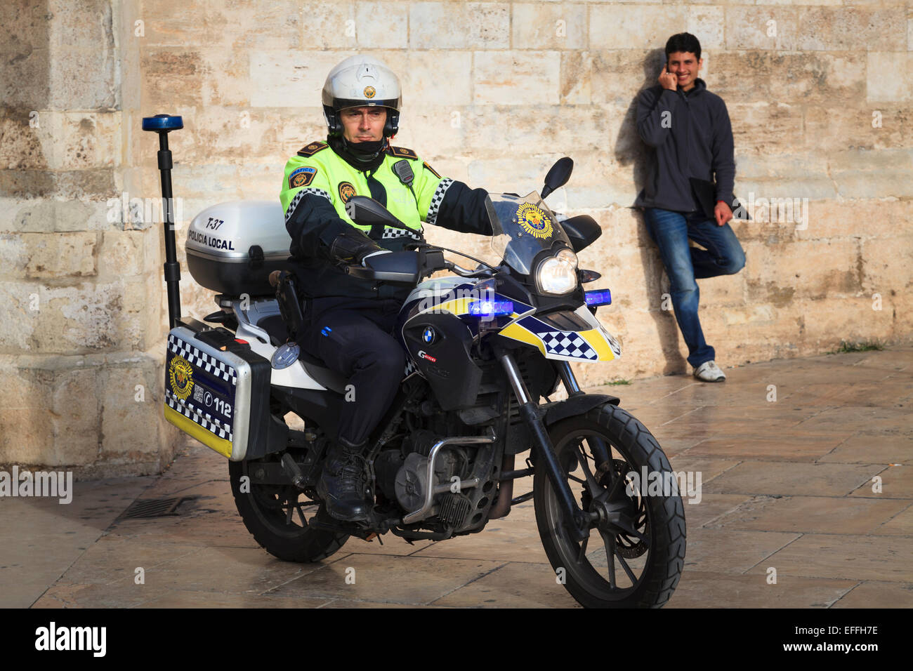 Spanish traffic police motorcyclist in pedestrian area of Valencia ...