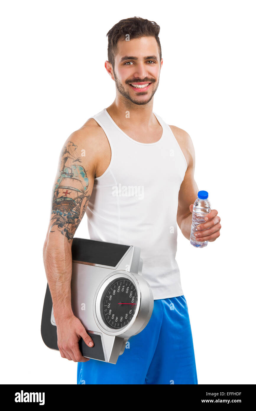 Athletic young man holding a scale and smile to the camera, isolated ...