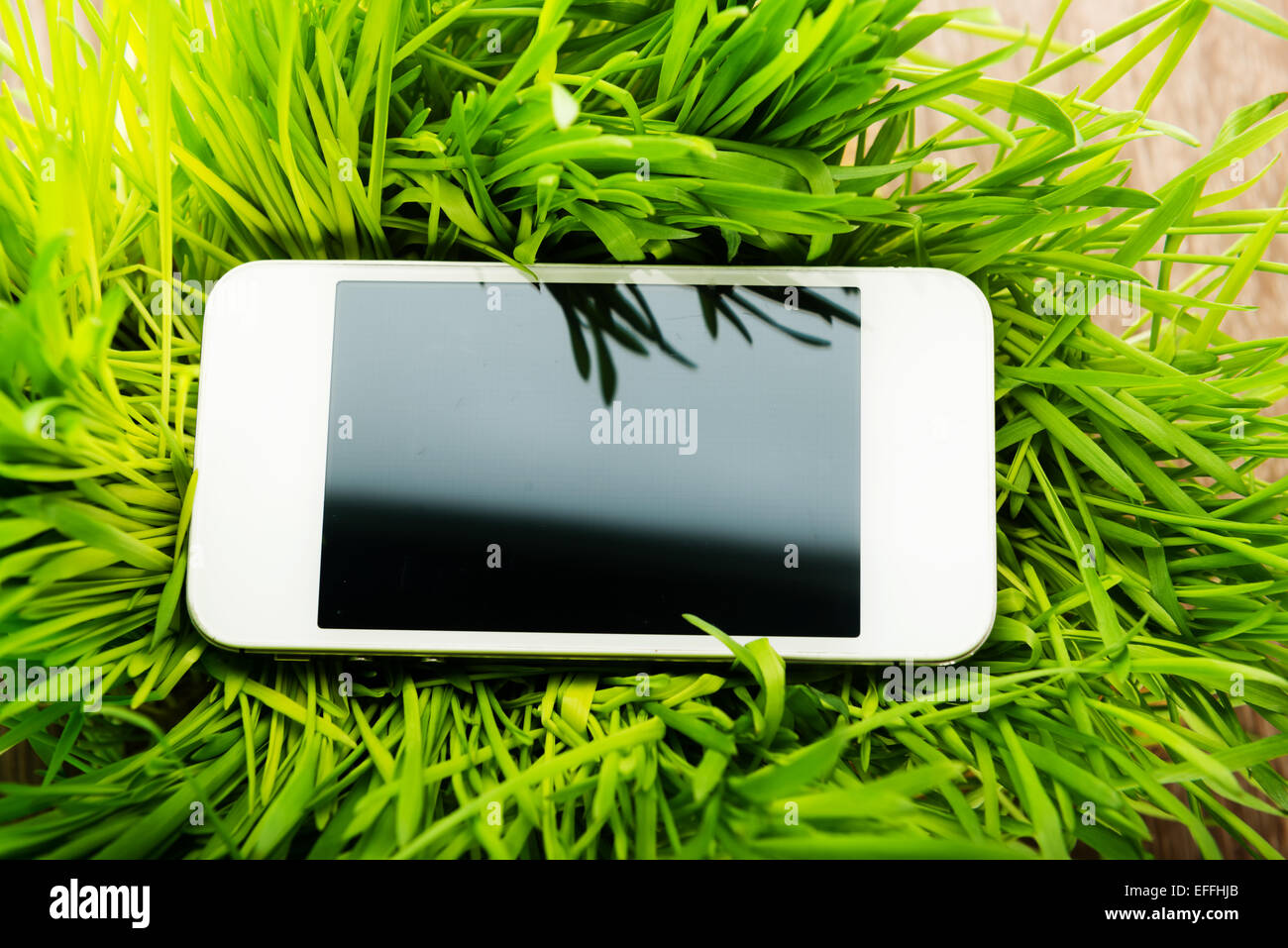 Mobile smart phone in green grass and black screen Stock Photo - Alamy